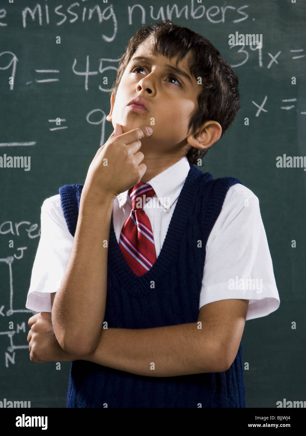 Boy at chalkboard with math formulas thinking Stock Photo - Alamy