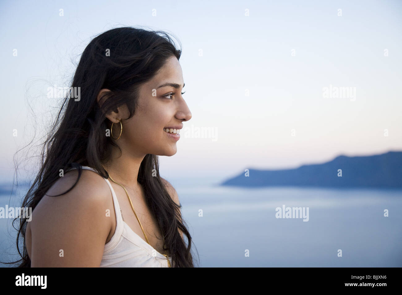 Profile of woman outdoors smiling Stock Photo - Alamy