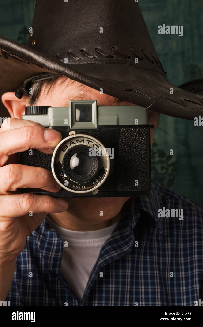 A photographer using an old (1964) toy camera Stock Photo - Alamy