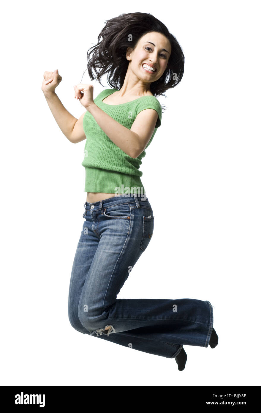 Woman leaping and smiling Stock Photo - Alamy