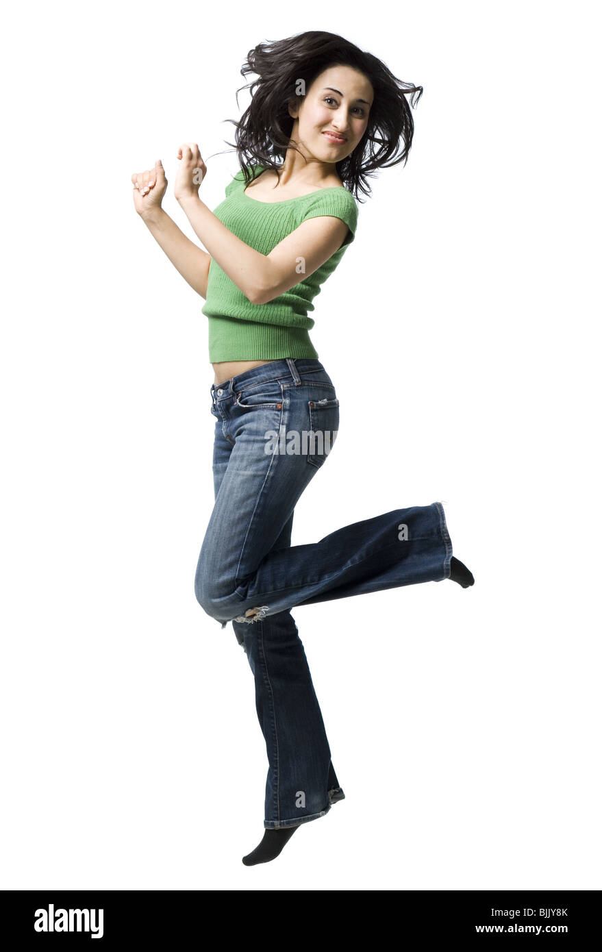 Woman leaping and smiling Stock Photo - Alamy