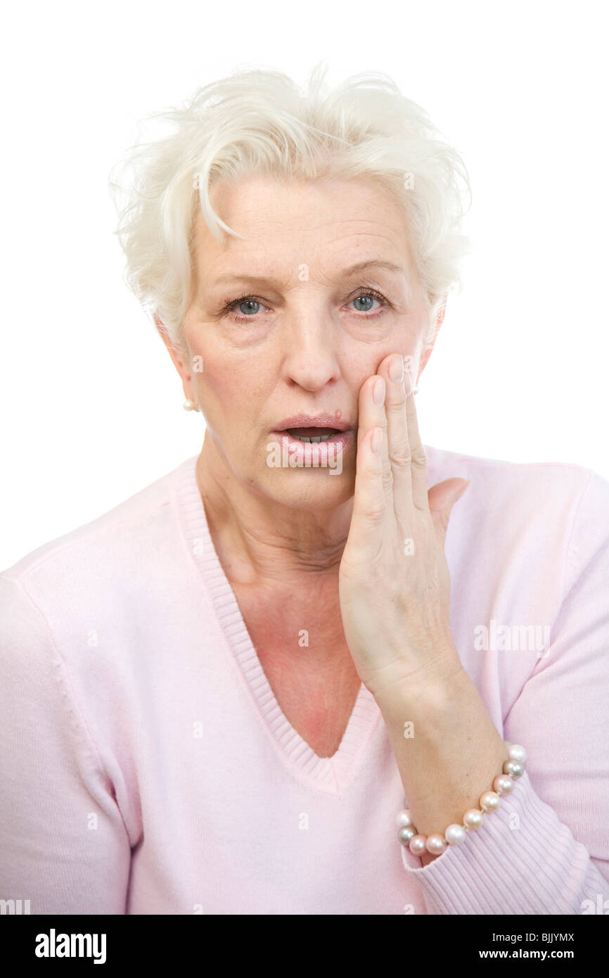 Woman holding her hand in horror on her cheek Stock Photo - Alamy