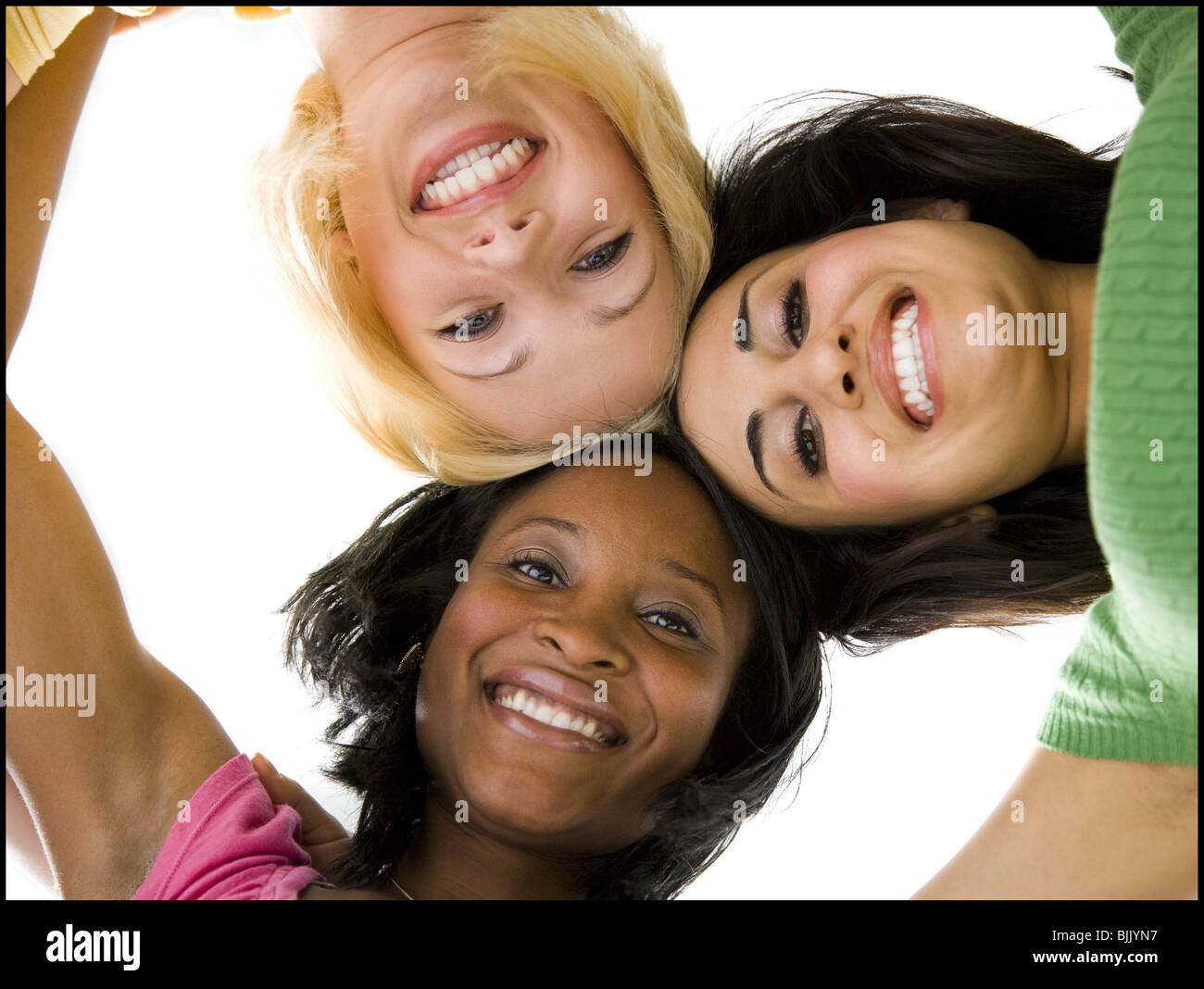 Three women hugging and smiling Stock Photo - Alamy