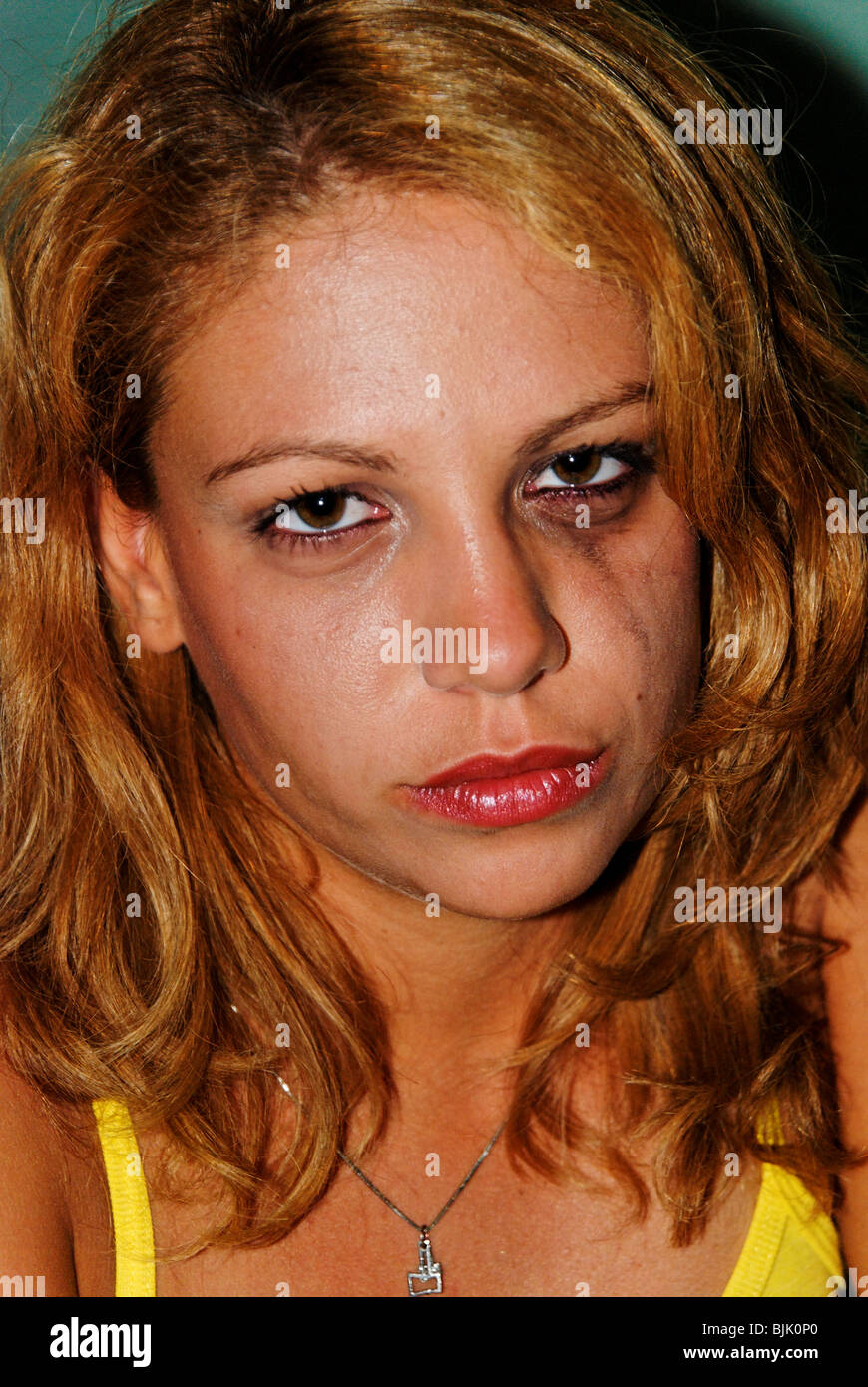 close emotive portrait of sad woman crying facing camera with smear ...