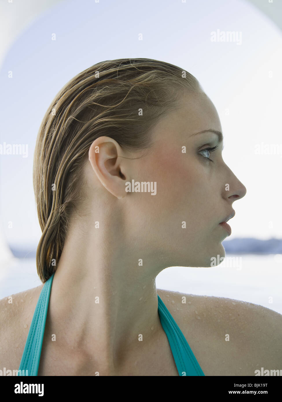 Profile of woman in bathing suit with wet hair Stock Photo - Alamy