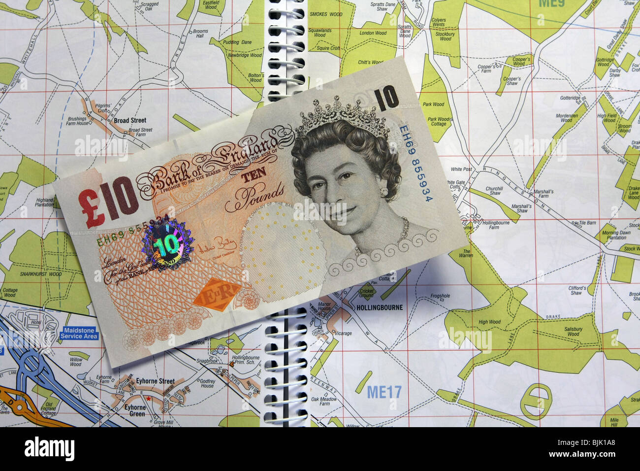 a £10 note on a page of an open road map Stock Photo - Alamy