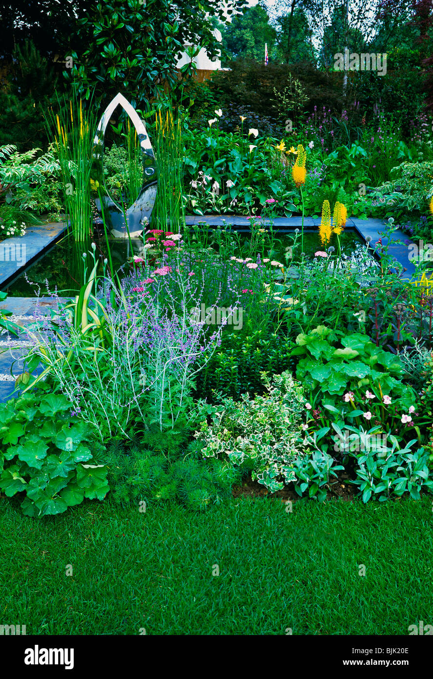 A colourful modern water garden with decorative feature Stock Photo - Alamy