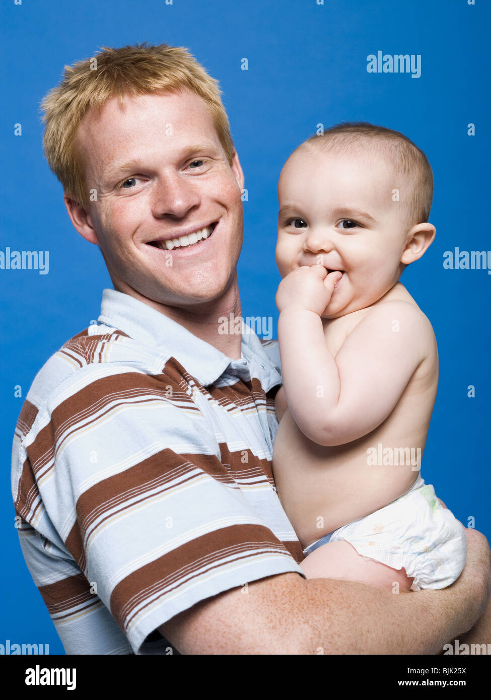 Man holding baby smiling Stock Photo - Alamy