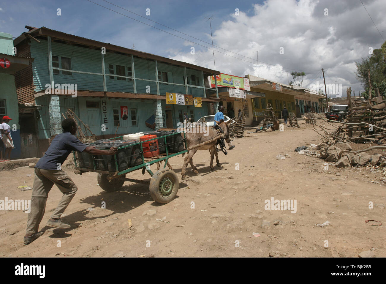 man pushing donkey cart Village Kenya Stock Photo - Alamy