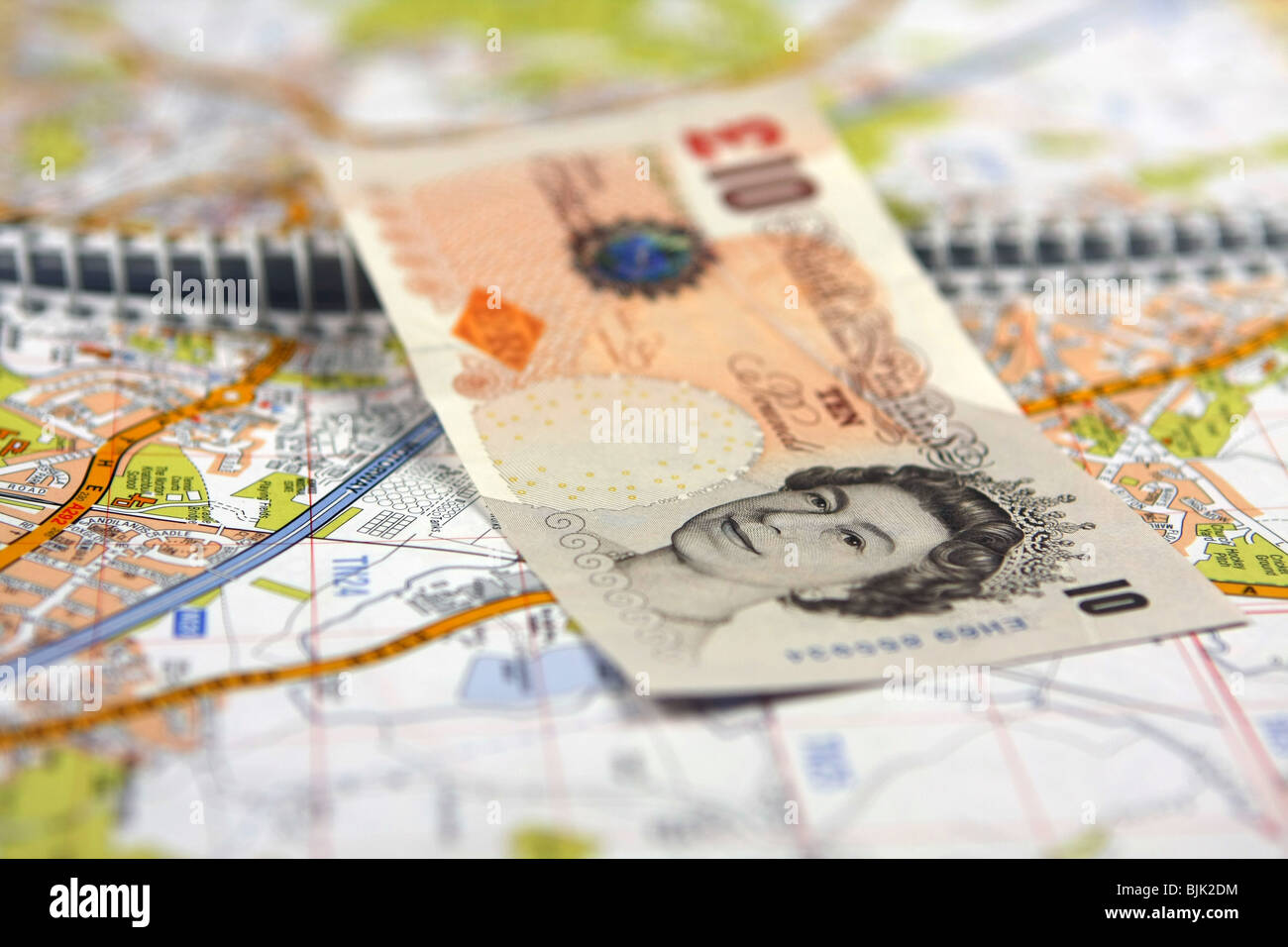 a £10 note on a page of an open road map Stock Photo - Alamy