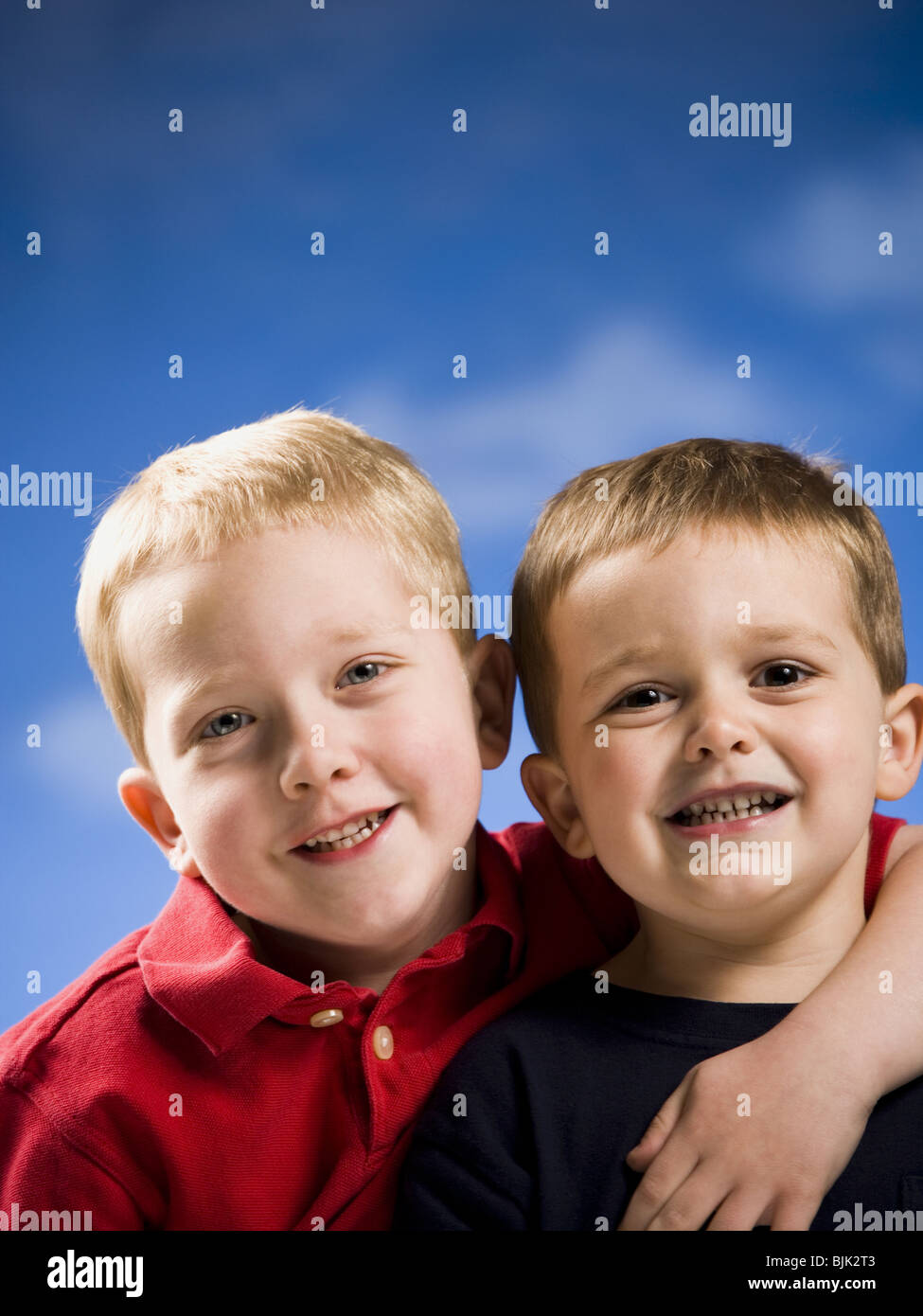 Two boys hugging and smiling Stock Photo - Alamy