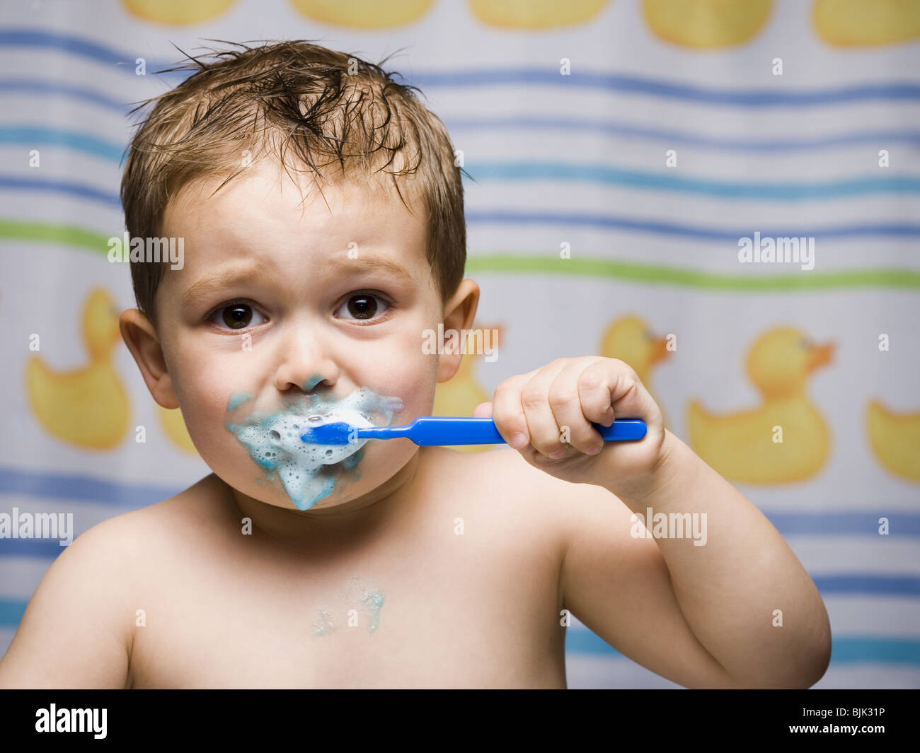 Boy brushing teeth in bathroom Stock Photo - Alamy