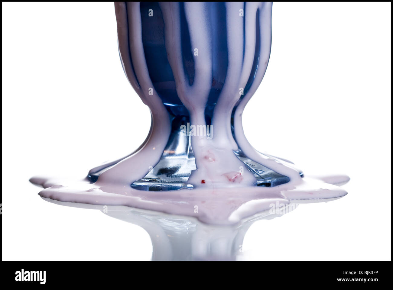 Close-up of base of melted milkshake with maraschino cherry Stock Photo ...
