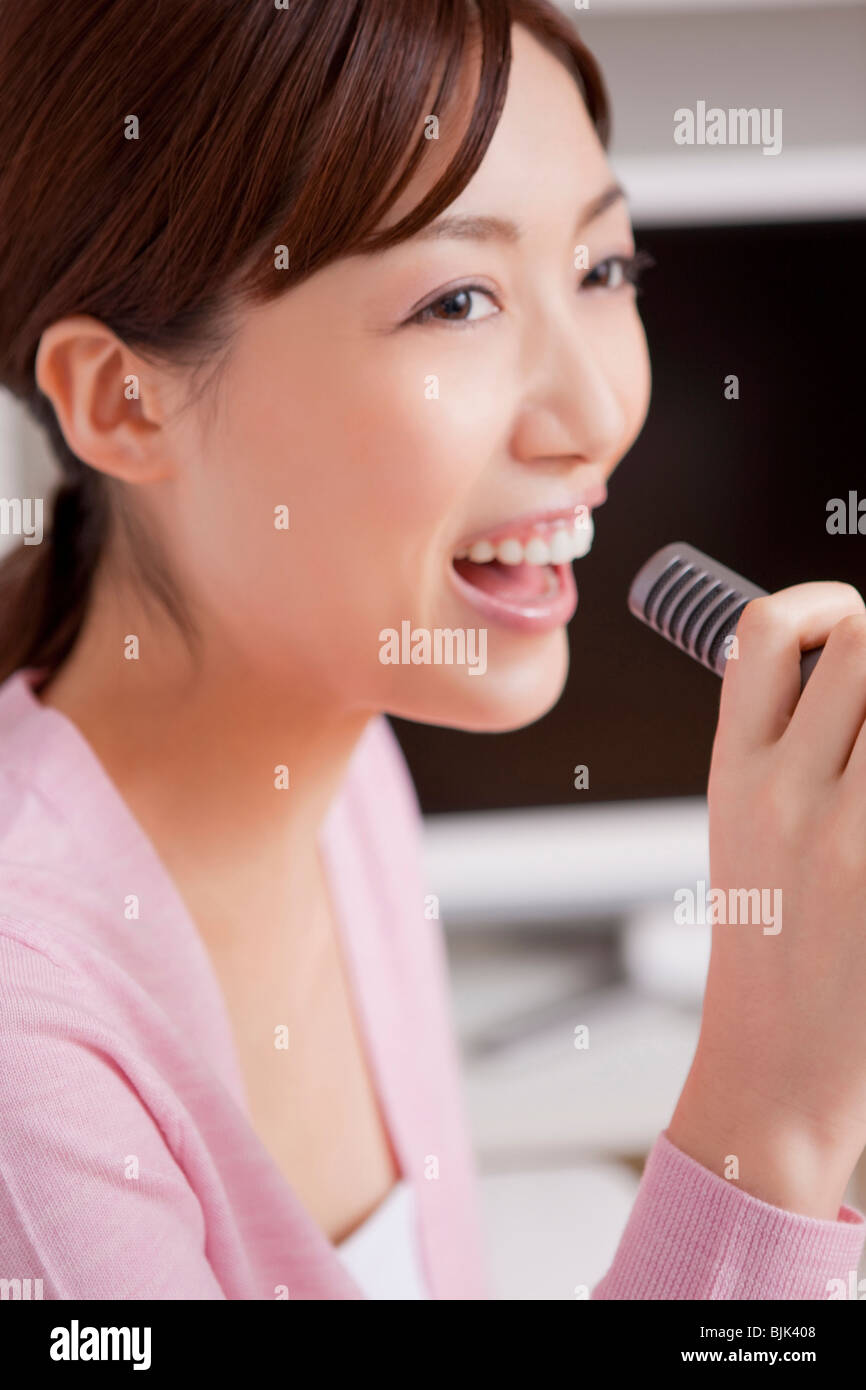 Young woman singing a song Stock Photo - Alamy