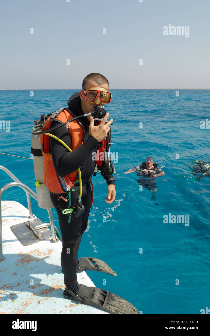 Diver on a boat before doing a giant stride to enter water Stock Photo ...