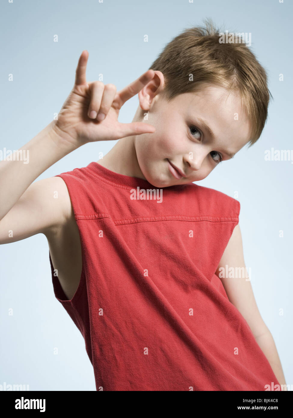 Portrait of a boy making hand gesture Stock Photo - Alamy
