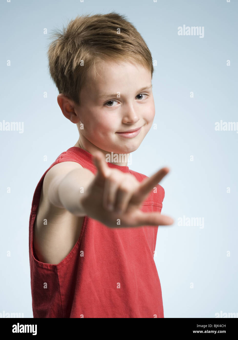 Portrait of a boy making hand gesture Stock Photo - Alamy