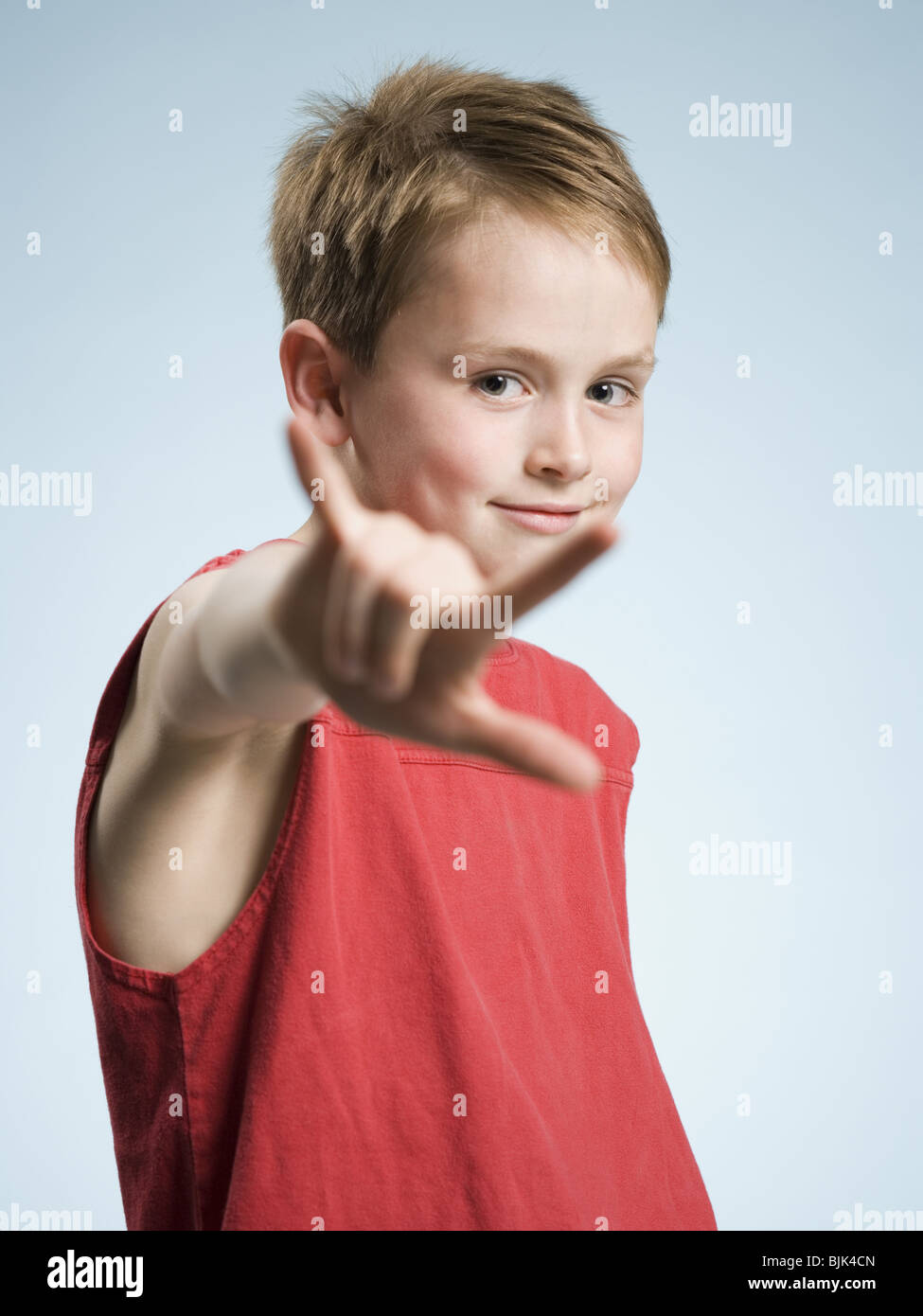 Portrait of a boy making hand gesture Stock Photo - Alamy
