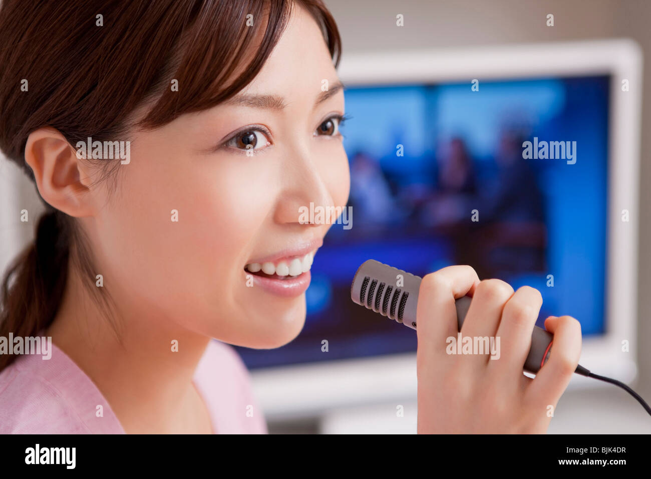 Young woman singing a song Stock Photo - Alamy