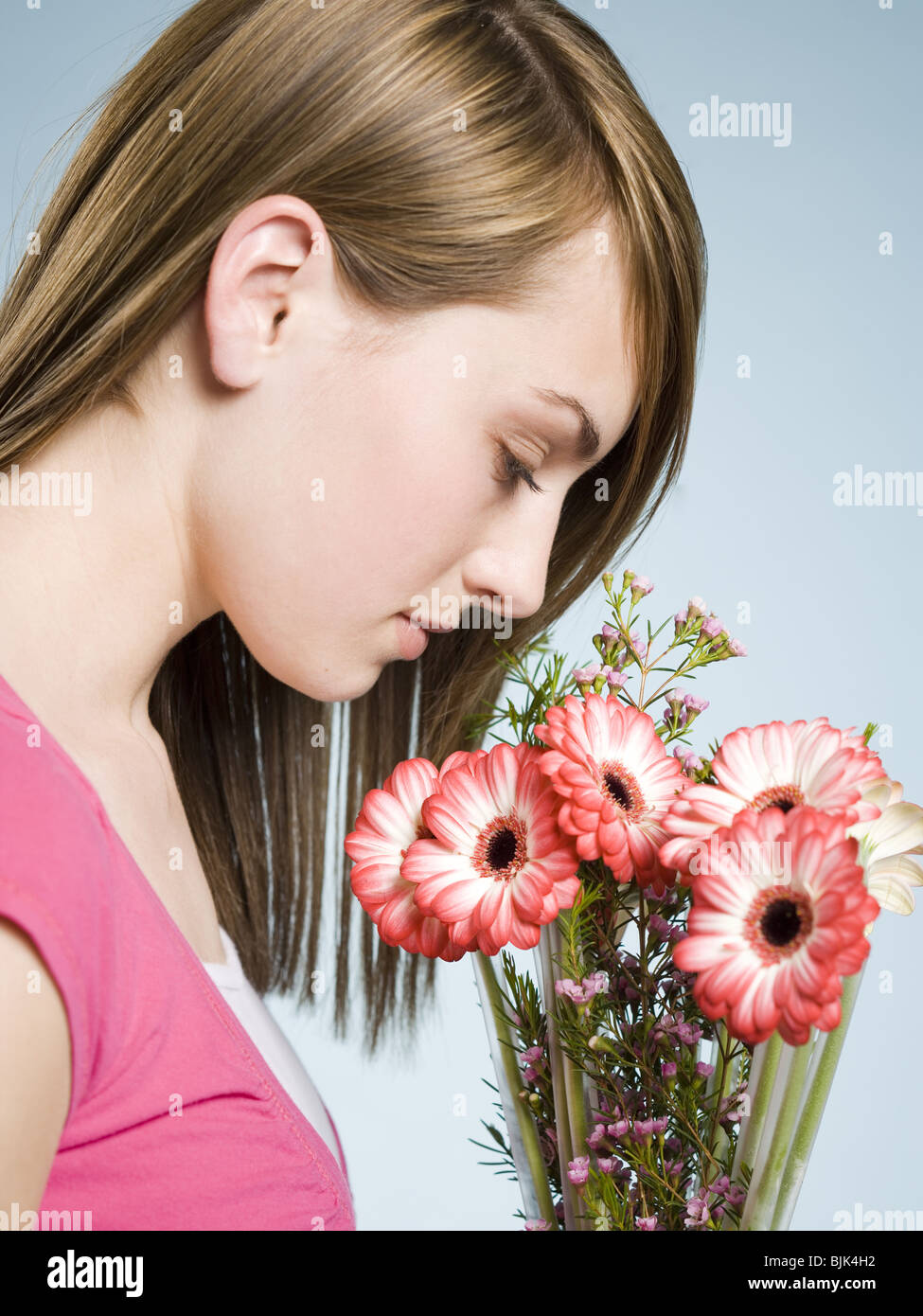 Profile of woman smelling flowers Stock Photo - Alamy