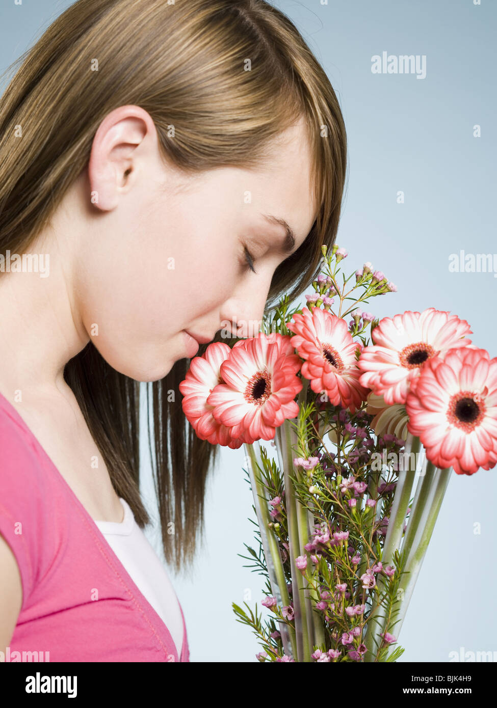 Profile of woman smelling flowers Stock Photo - Alamy
