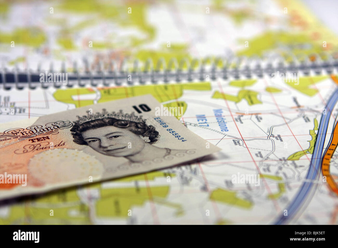 a £10 note on a page of an open road map Stock Photo - Alamy