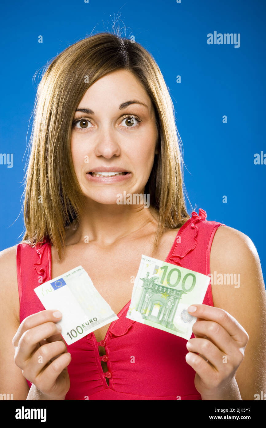 Woman with torn one hundred euro banknote Stock Photo - Alamy
