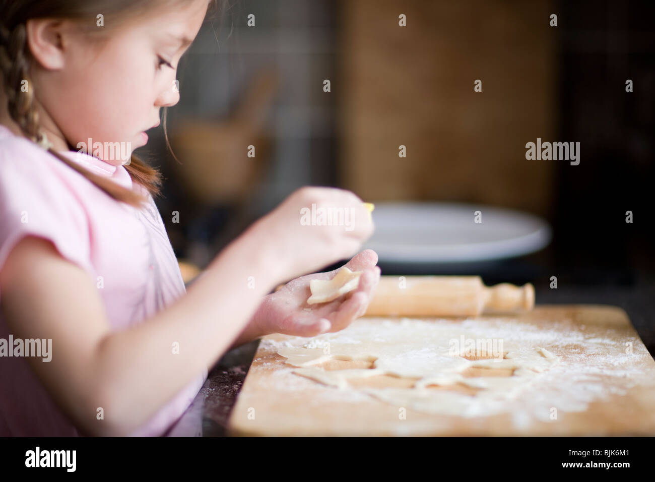 Close up of young girl cutting shapes from baking dough Stock Photo - Alamy