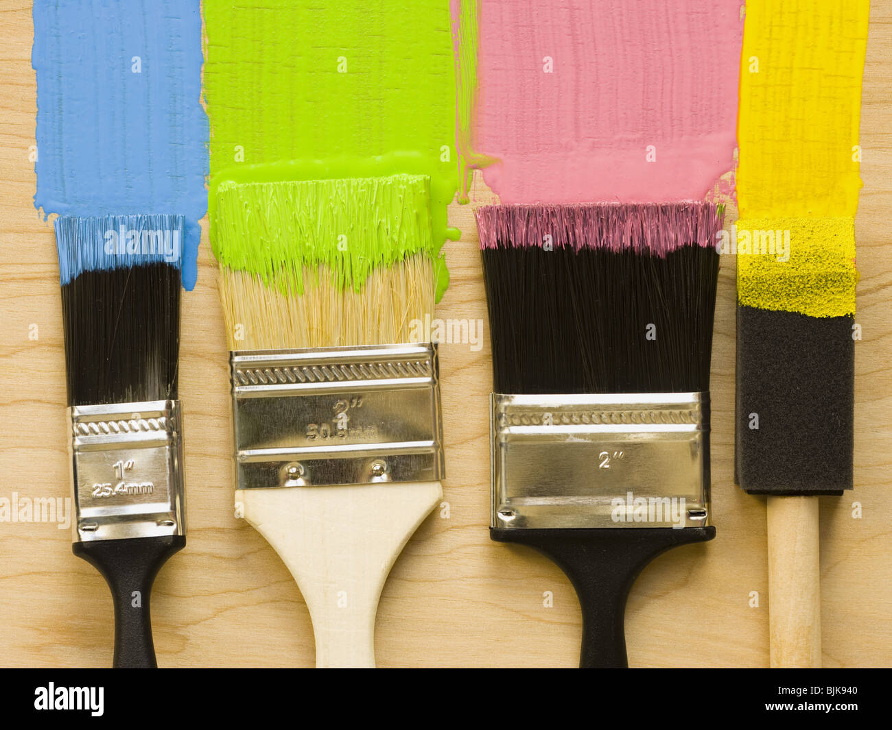Four paint brushes with stripes of paint Stock Photo - Alamy