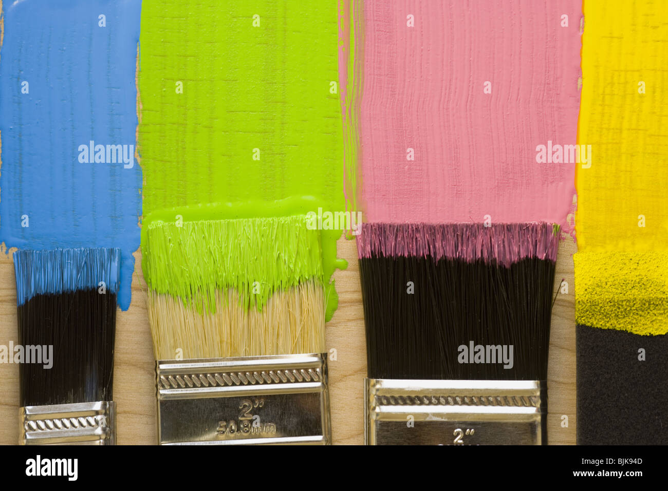 Four paint brushes with stripes of paint Stock Photo - Alamy