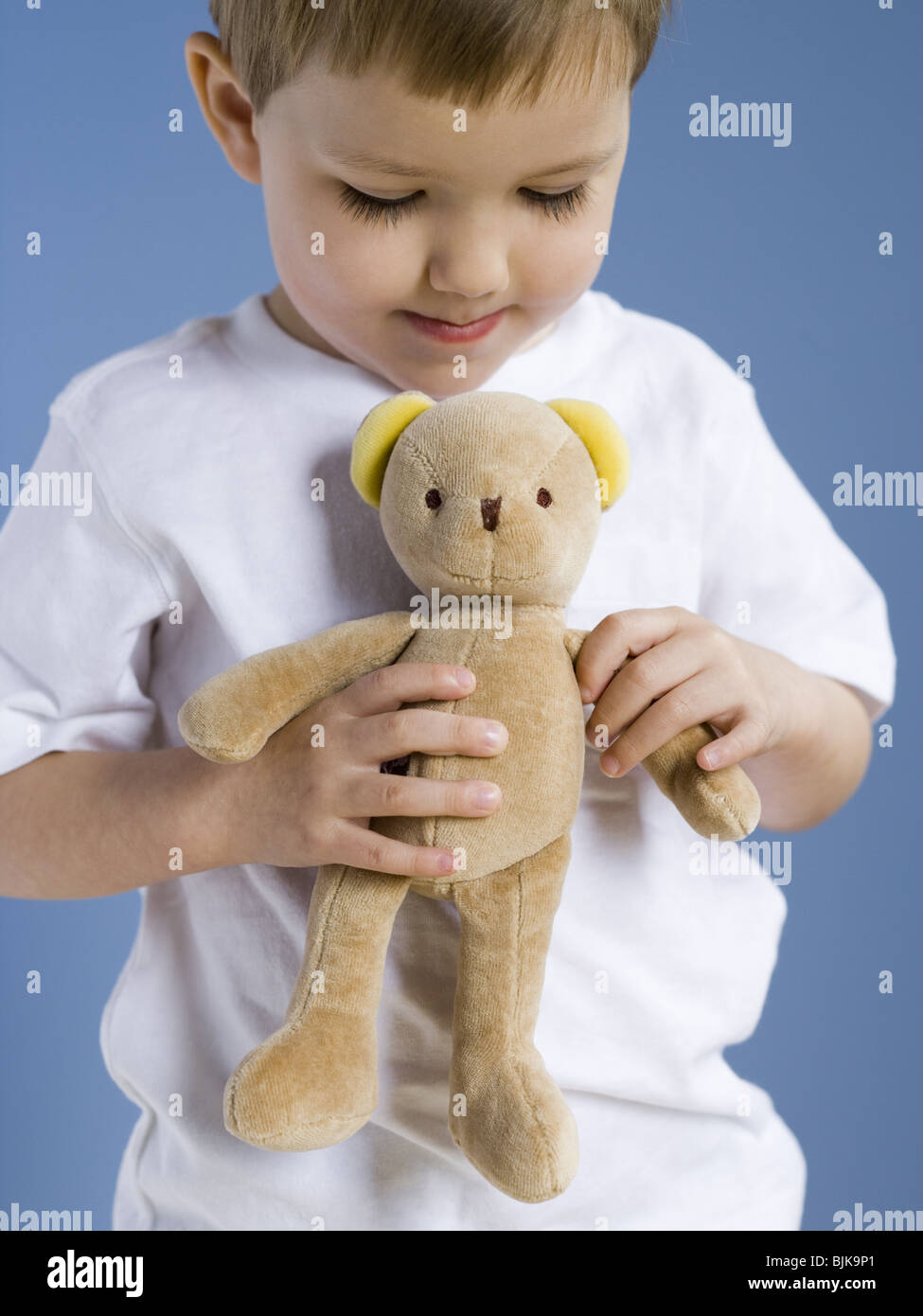 Closeup of boy holding teddy bear Stock Photo - Alamy