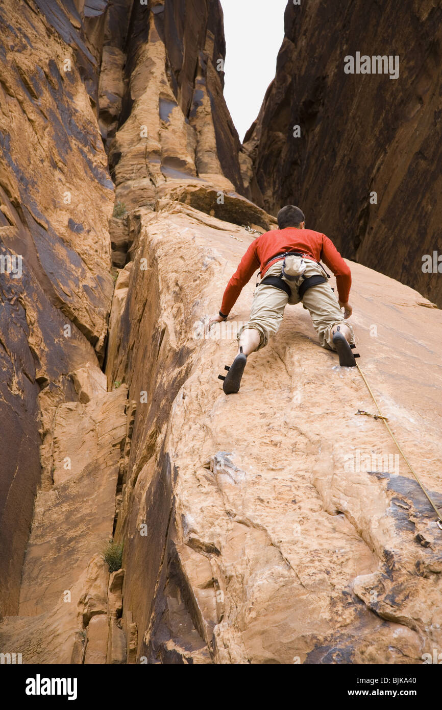 Man climbing mountain Stock Photo - Alamy