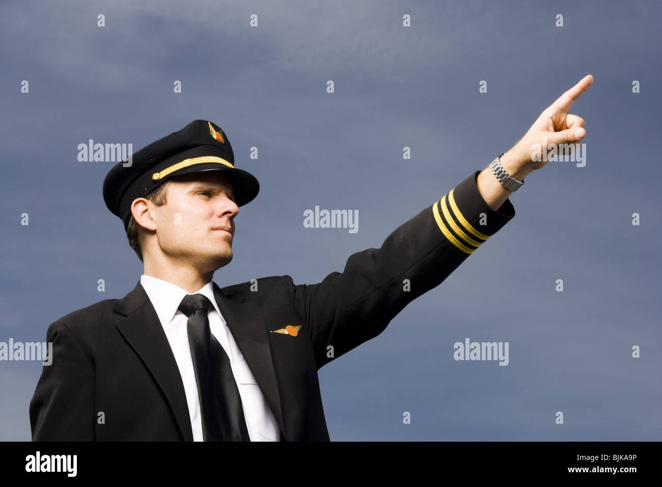 Pilot standing with arms crossed outdoors Stock Photo - Alamy
