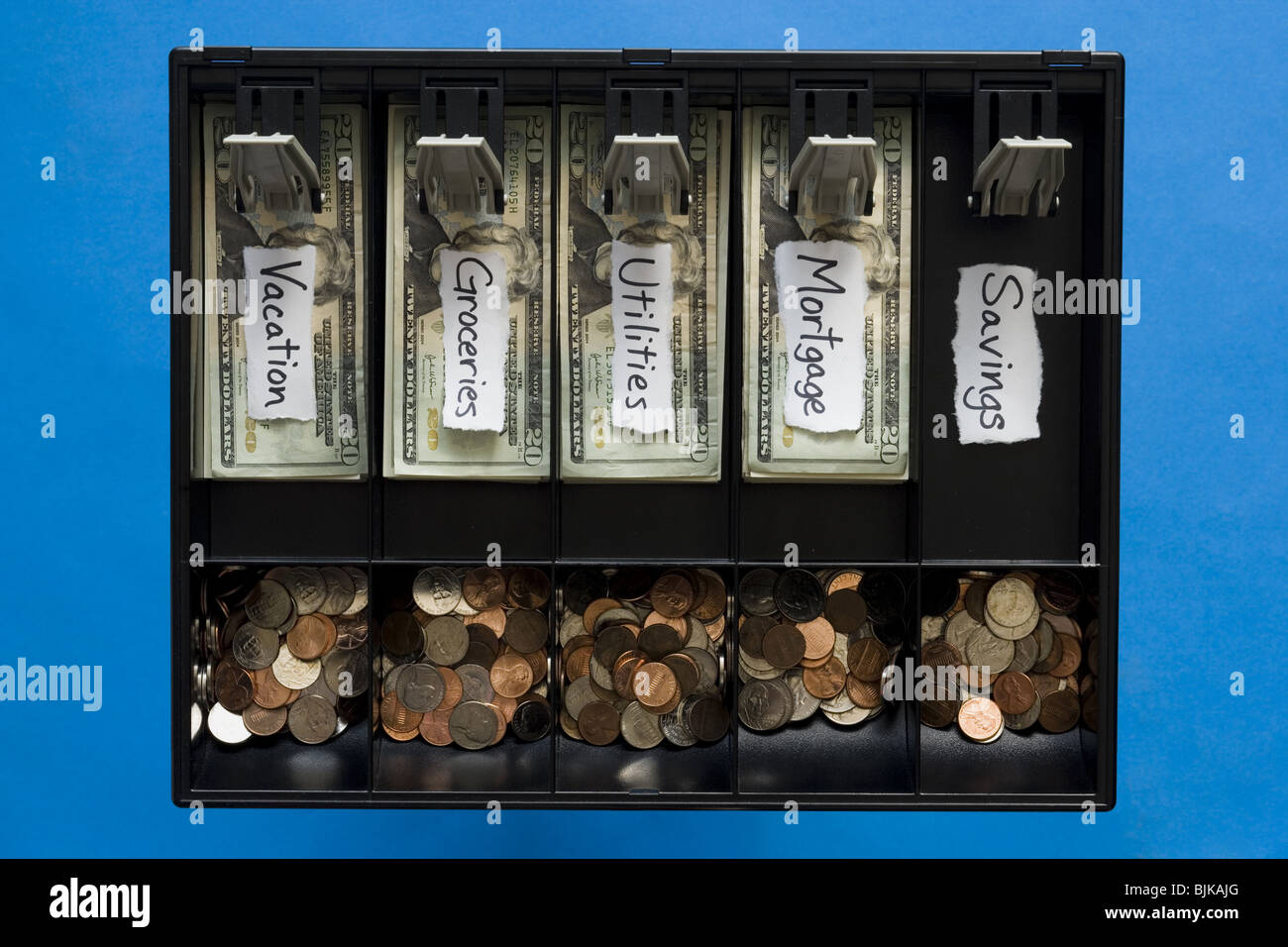 Detailed view of US currency and coins in till with labels for ...