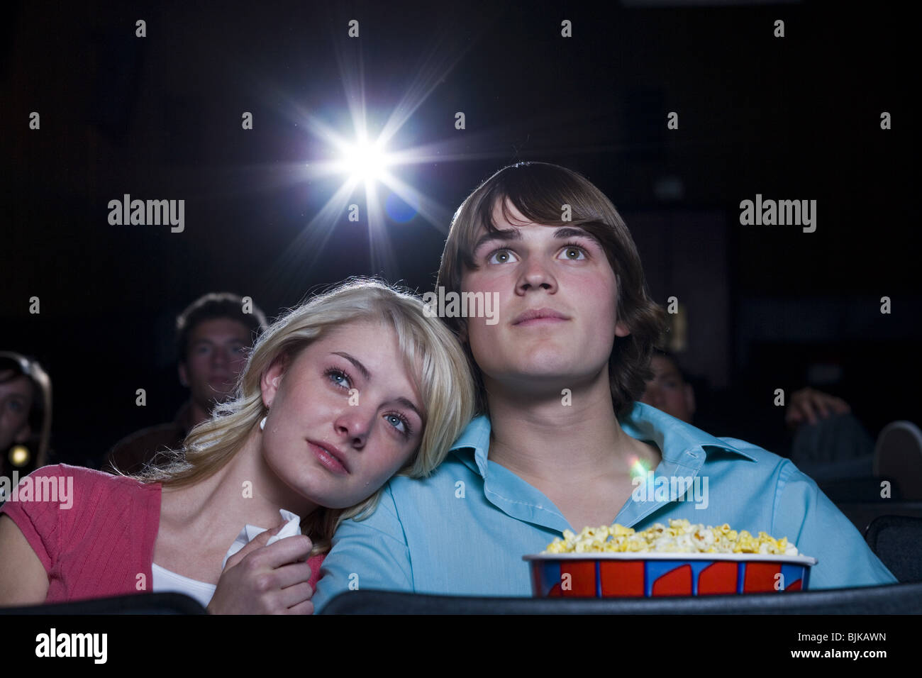 Girl crying at movie theater with boy and popcorn Stock Photo - Alamy
