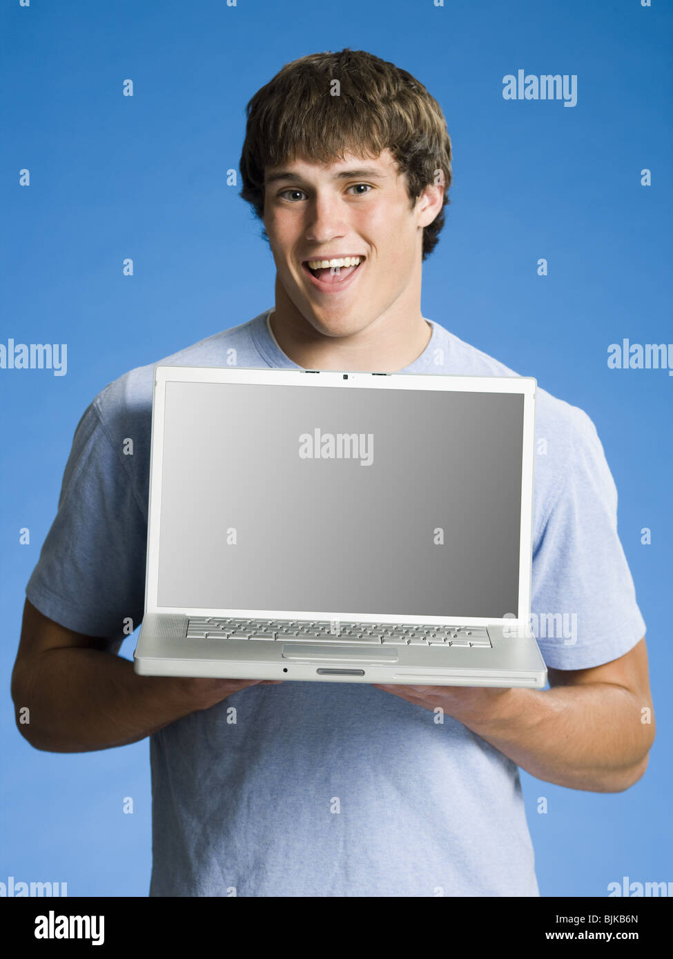 Boy with laptop smiling Stock Photo - Alamy