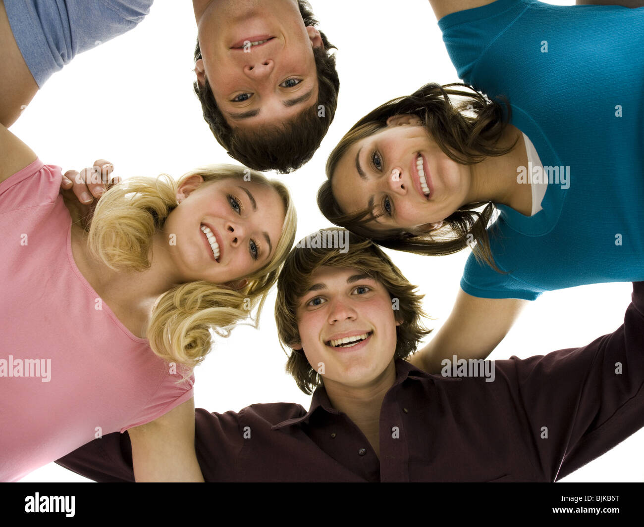 Low level view of four people smiling Stock Photo - Alamy
