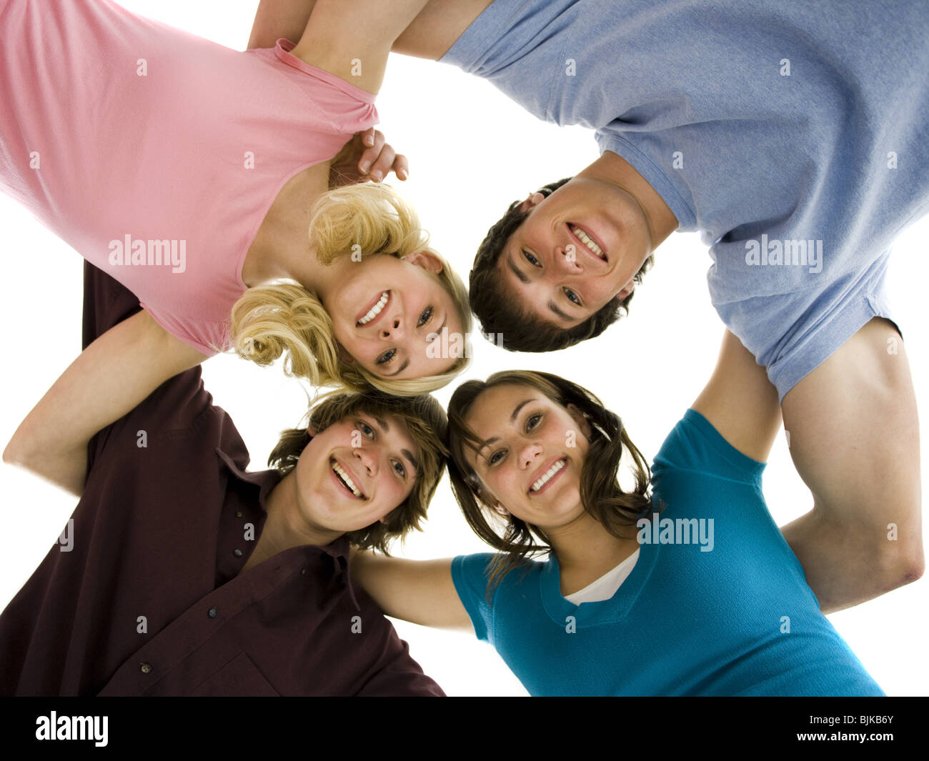 Low level view of four people smiling Stock Photo - Alamy