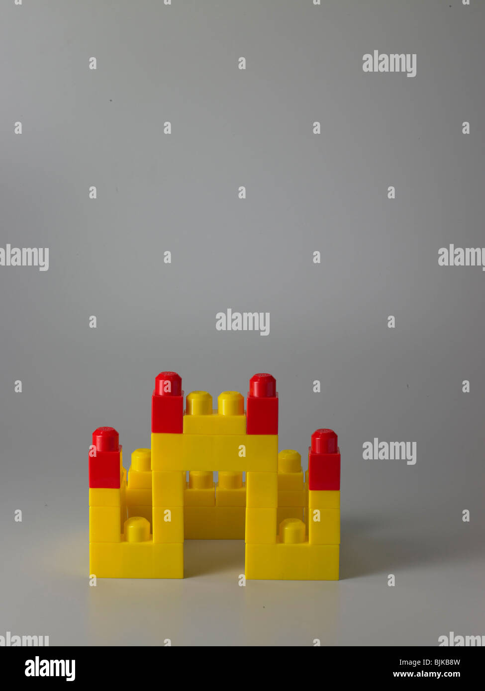 Yellow toy blocks showing building and structure. face on Stock Photo ...