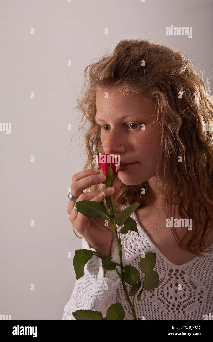Woman smelling a rose Stock Photo - Alamy