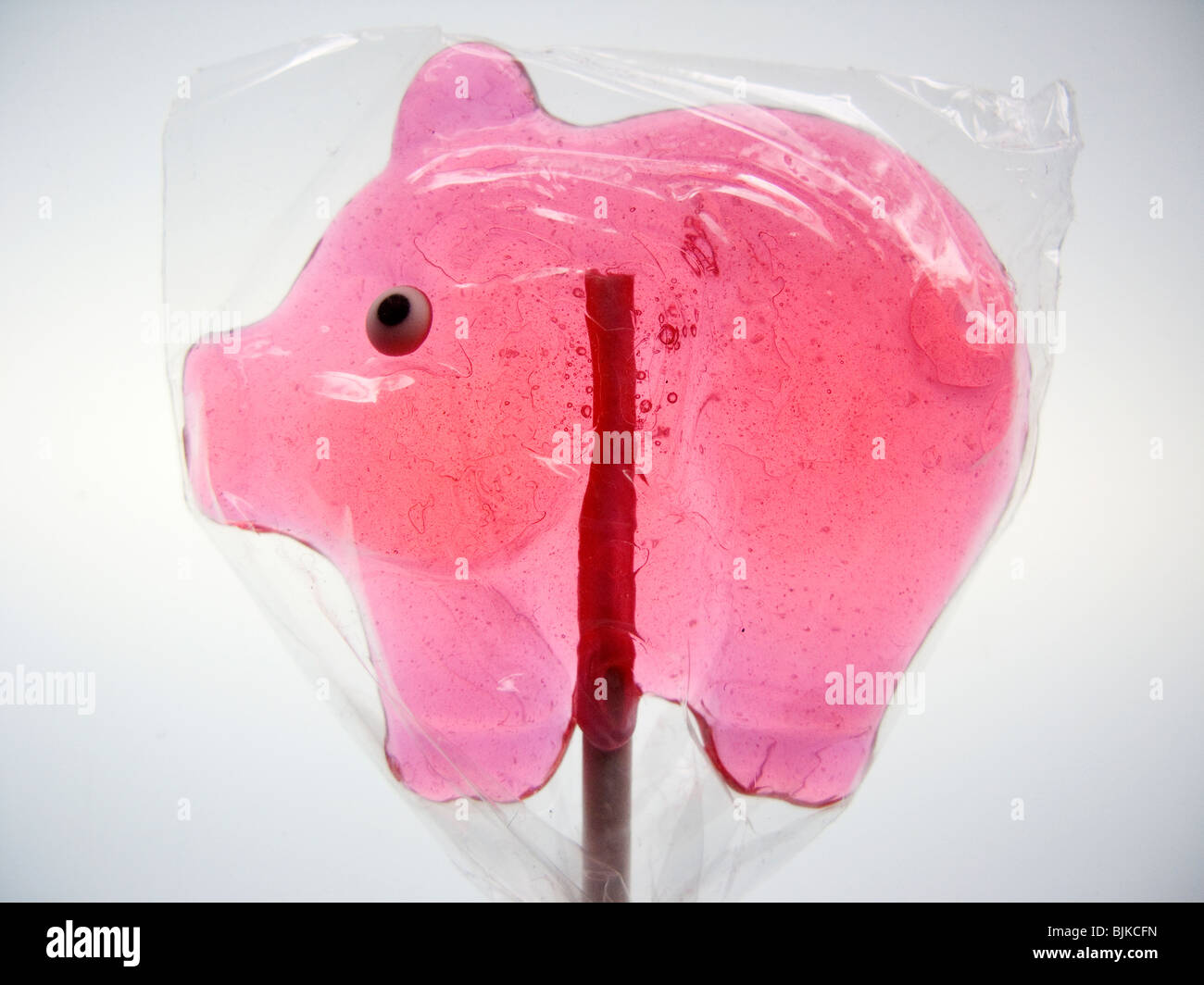 Pig shaped lollipop candy translucent poked with stick and wrapped in ...