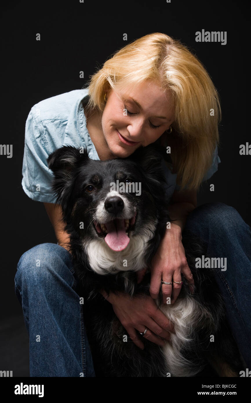 Portrait of a woman with black dog Stock Photo - Alamy
