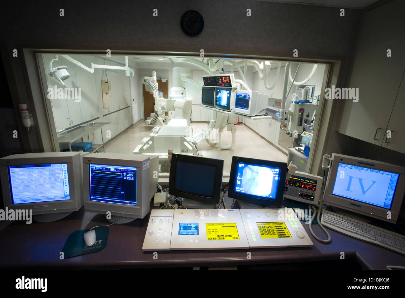Male x-ray technician sitting at computers Stock Photo - Alamy