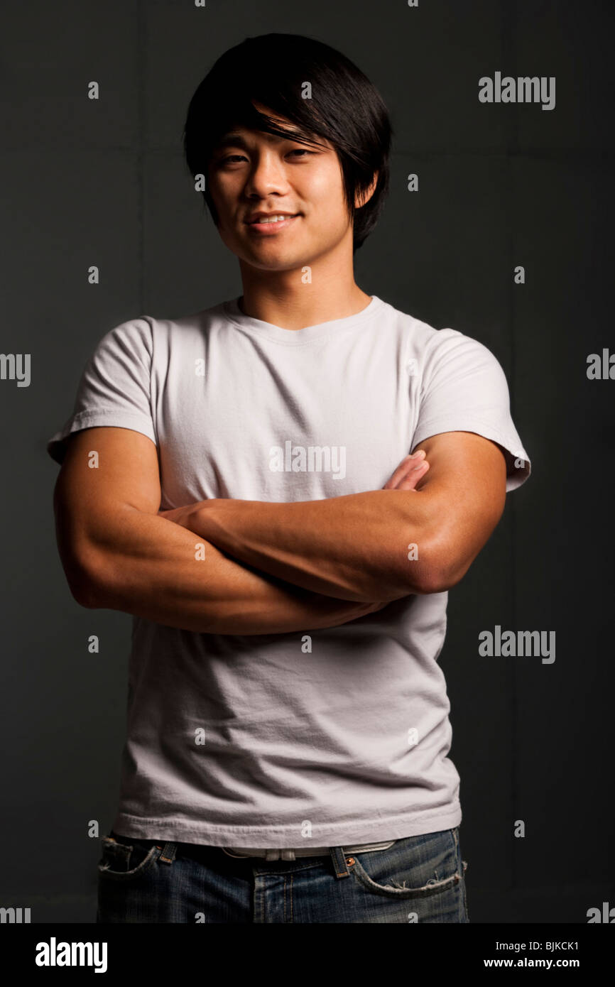 Muscular man with eyeglasses smiling Stock Photo - Alamy