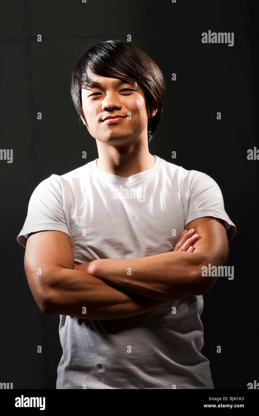 Muscular man with eyeglasses smiling Stock Photo - Alamy
