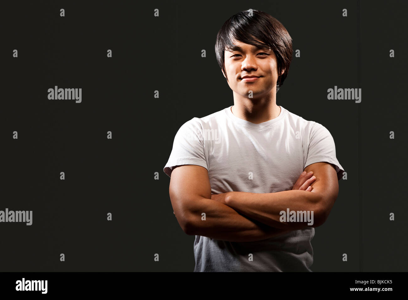 Muscular man with eyeglasses smiling Stock Photo - Alamy