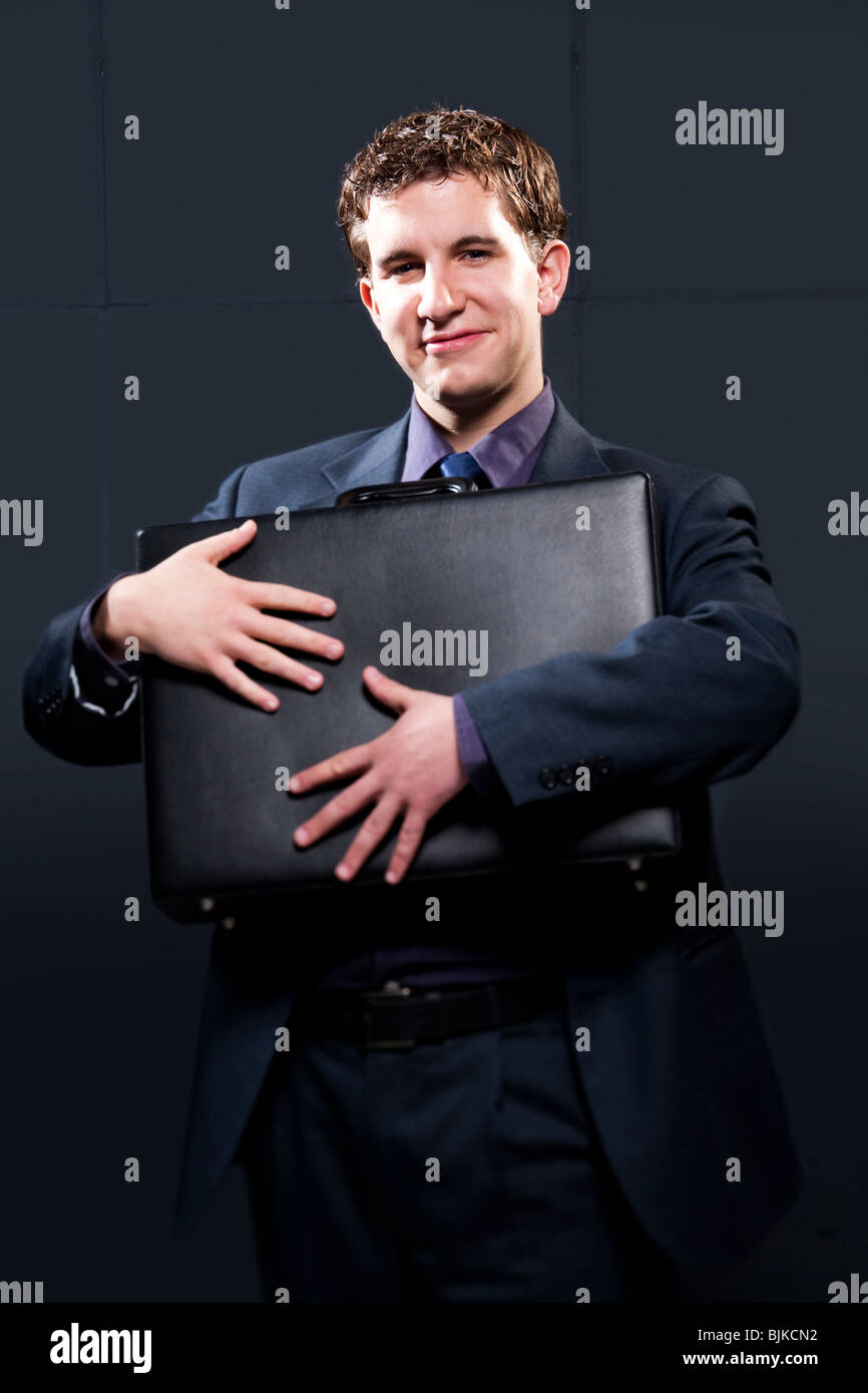 Business man with briefcase and arm up smiling Stock Photo - Alamy