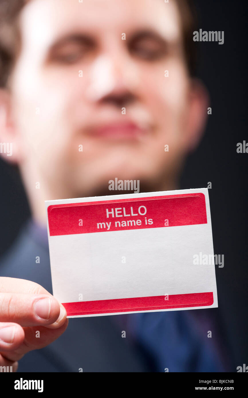 Man holding blank name tag Stock Photo - Alamy