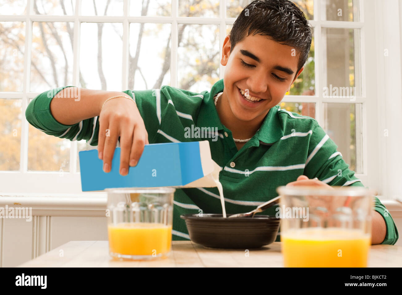 Boy eating breakfast Stock Photo - Alamy