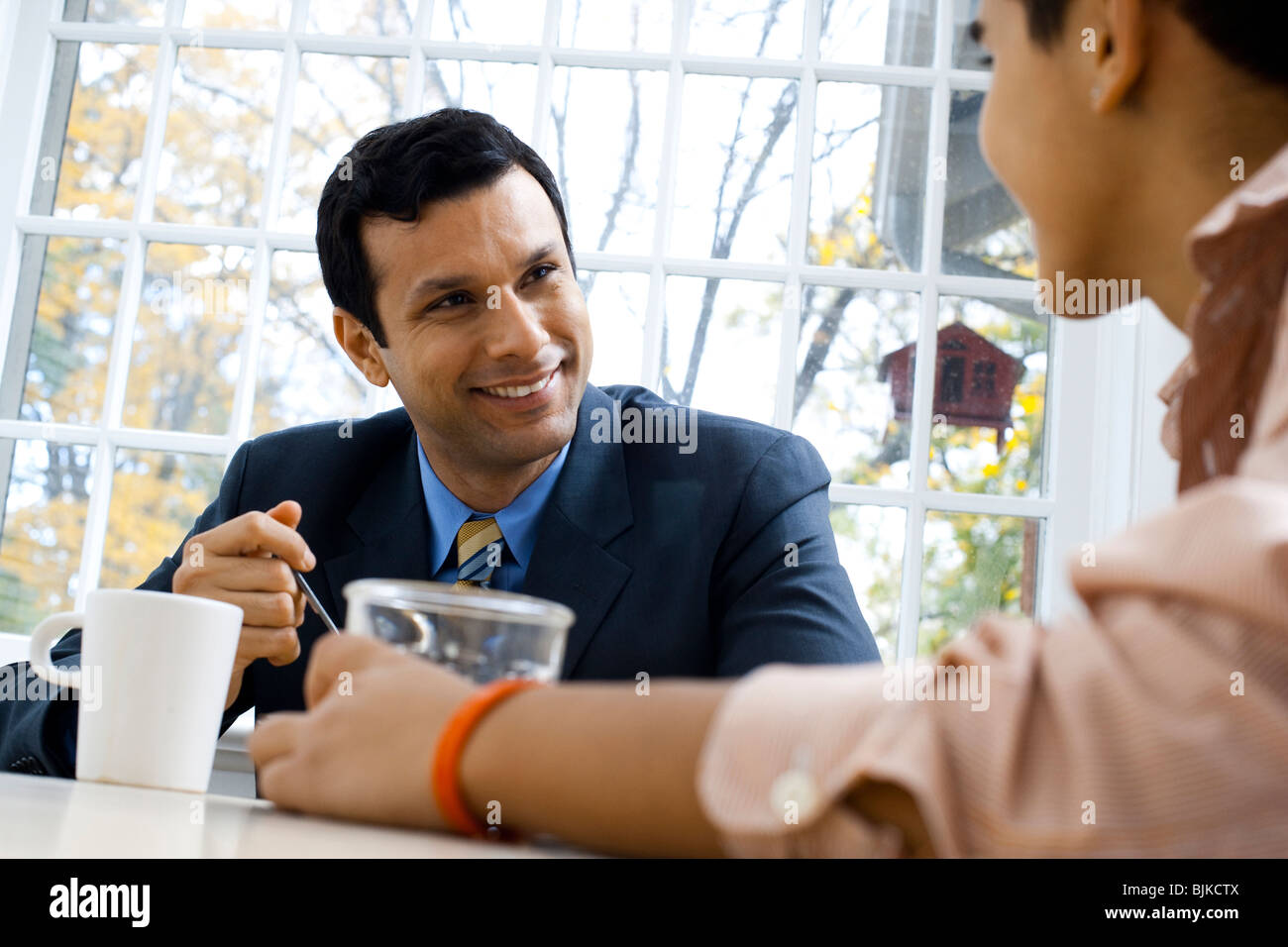 Man and boy at breakfast table smiling Stock Photo - Alamy
